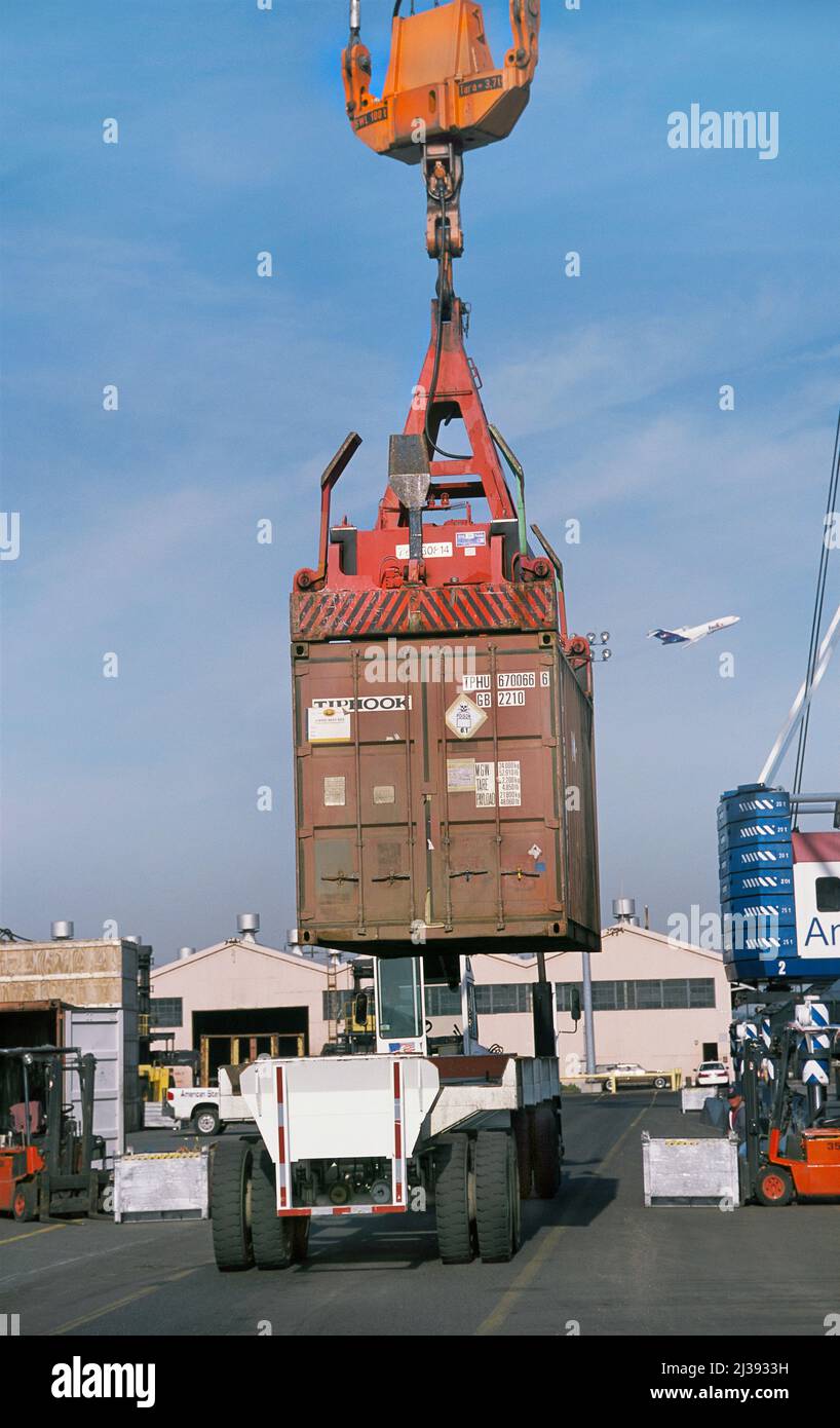 Shipping sea container hoisted by crane Industrial port. Tariffs. Fedex ...