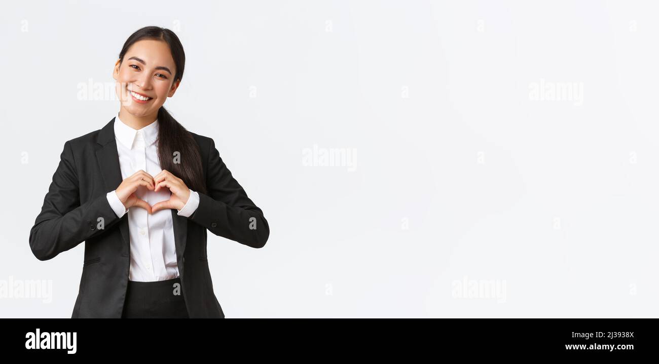 Cheerful successful asian businesswoman in black suit care for her ...