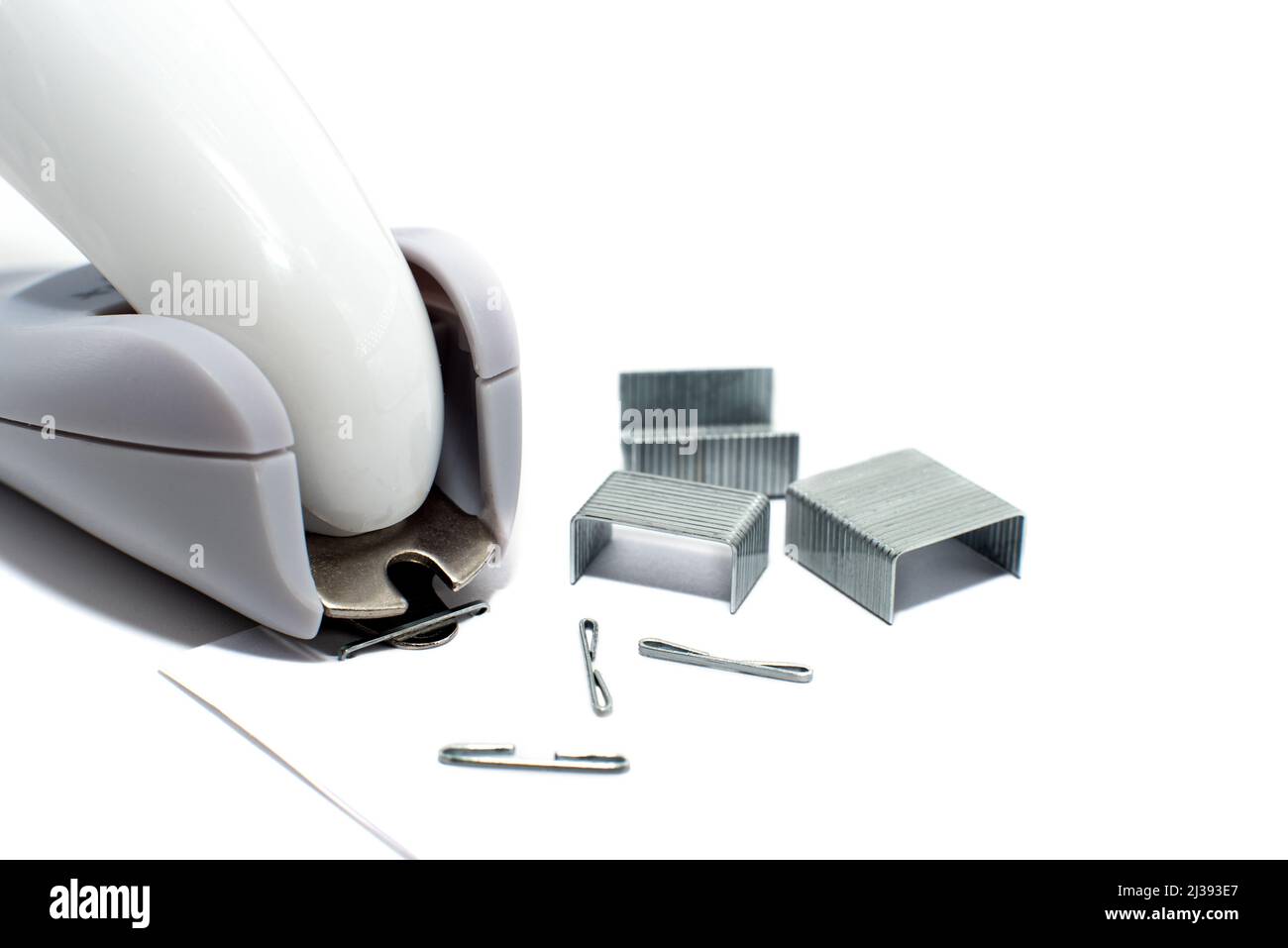 Anti-stapler with clerical staples on a white background. Stationery ...