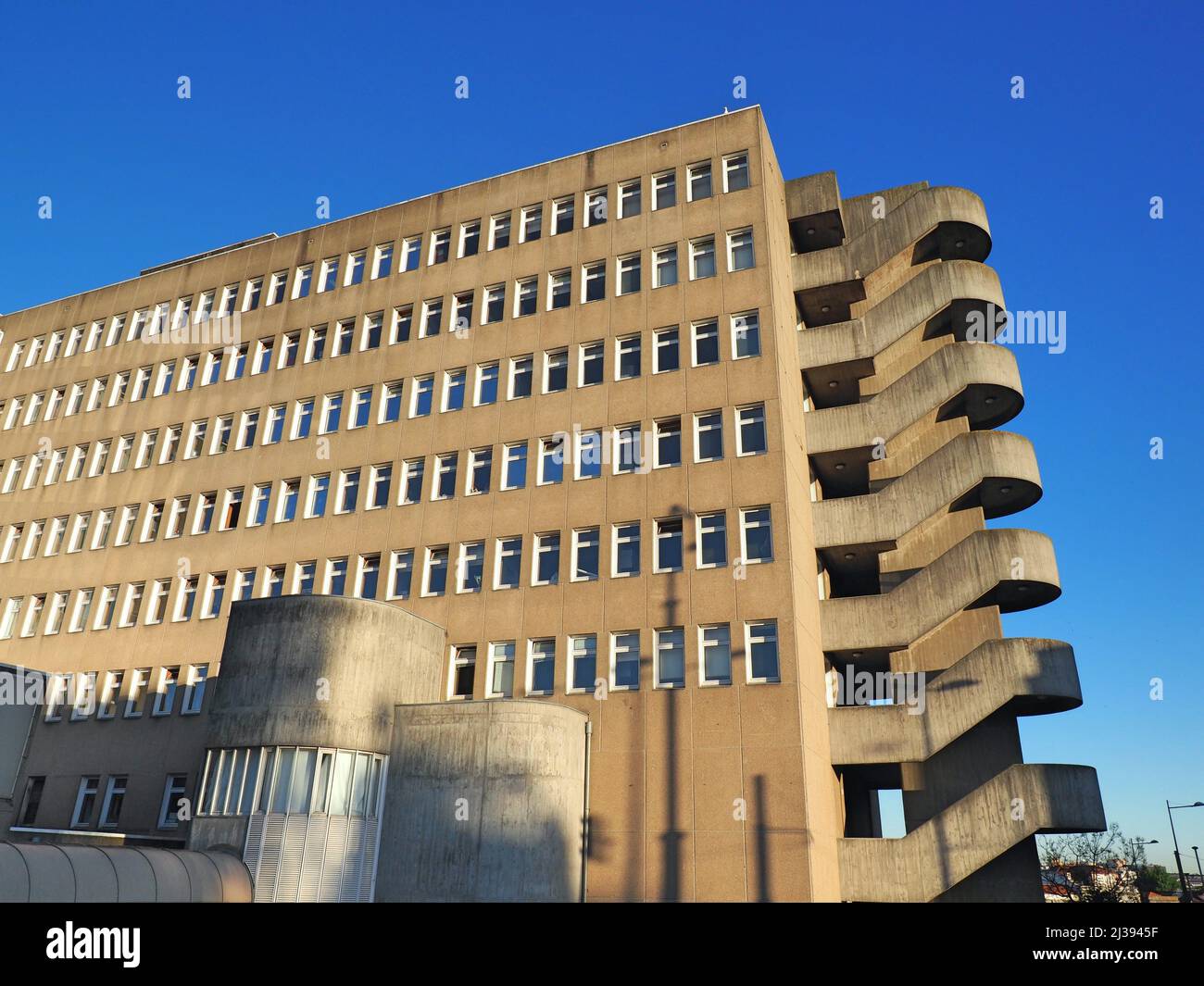 A view of a building with an open air staircase in the sunlight Stock ...
