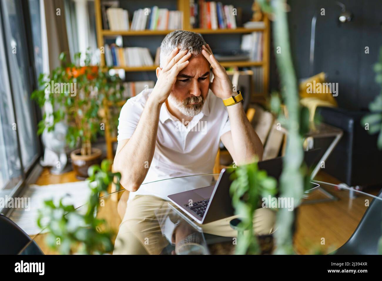 Mature adult businessman headache typing hi-res stock photography and ...