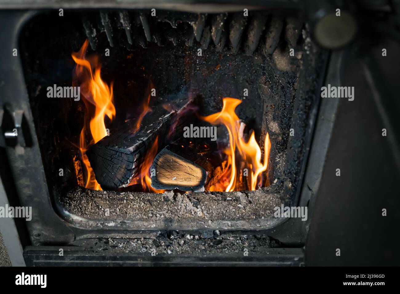 Firewood burns in a solid fuel water boiler. Open boiler door Stock ...