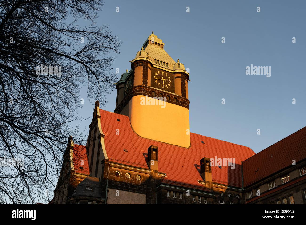 Tower of the Georg Schumann Building in the orange sunset light. The ...