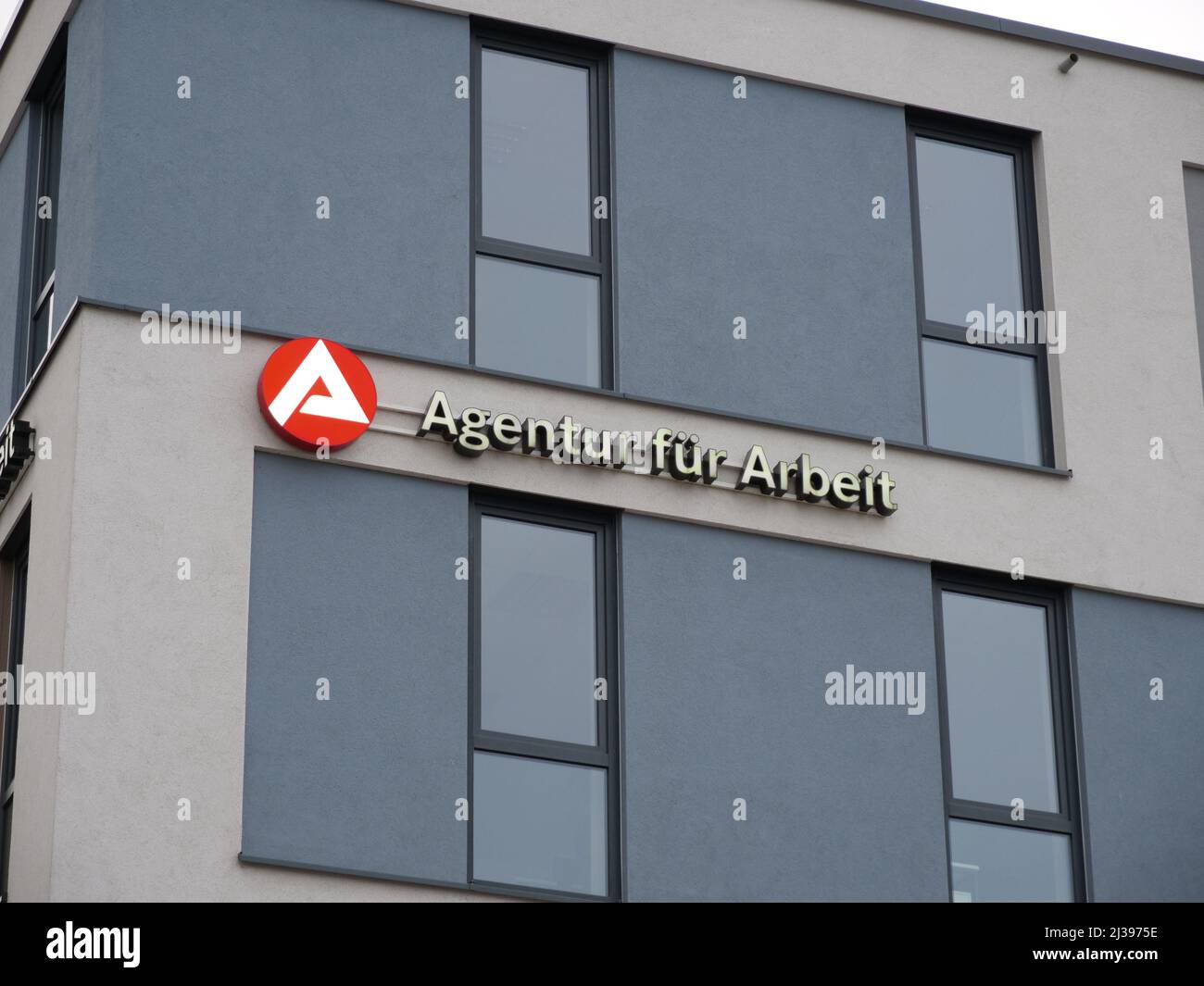 Employment agency logo sign on the facade of a building. An ...