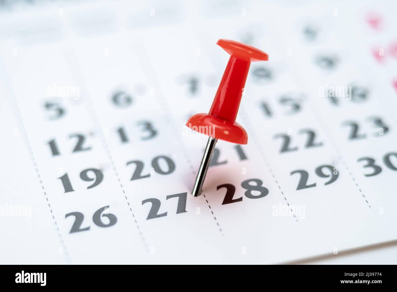 Red push pin on calendar 27th day of the month, mark the Event day with ...