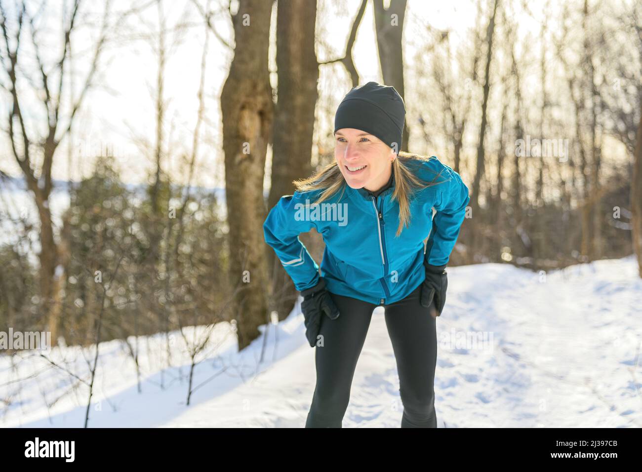 Woman Running in Snowy Park in winter season Stock Photo - Alamy