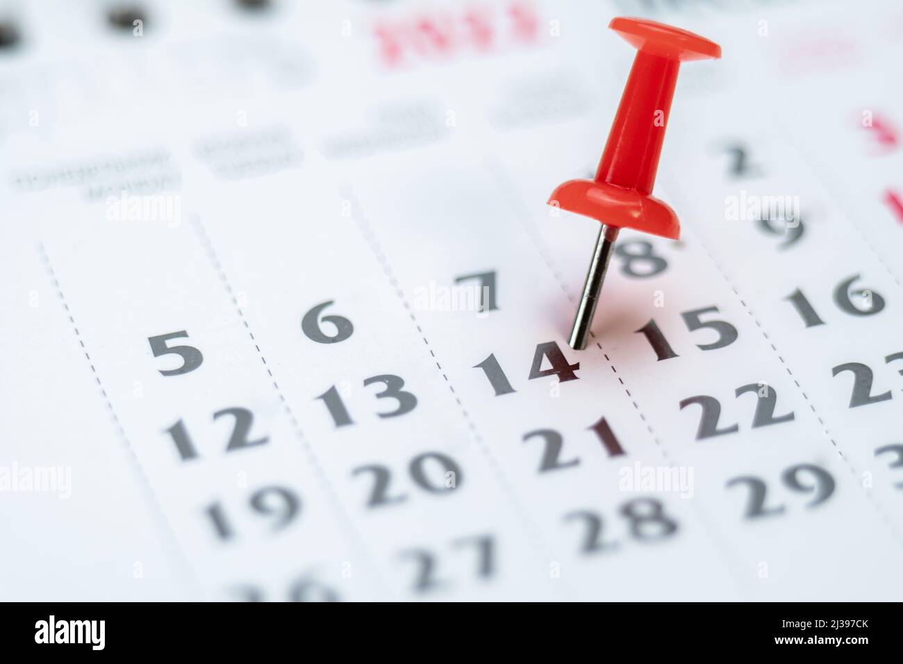Red push pin on calendar 14th day of the month, mark the Event day with ...