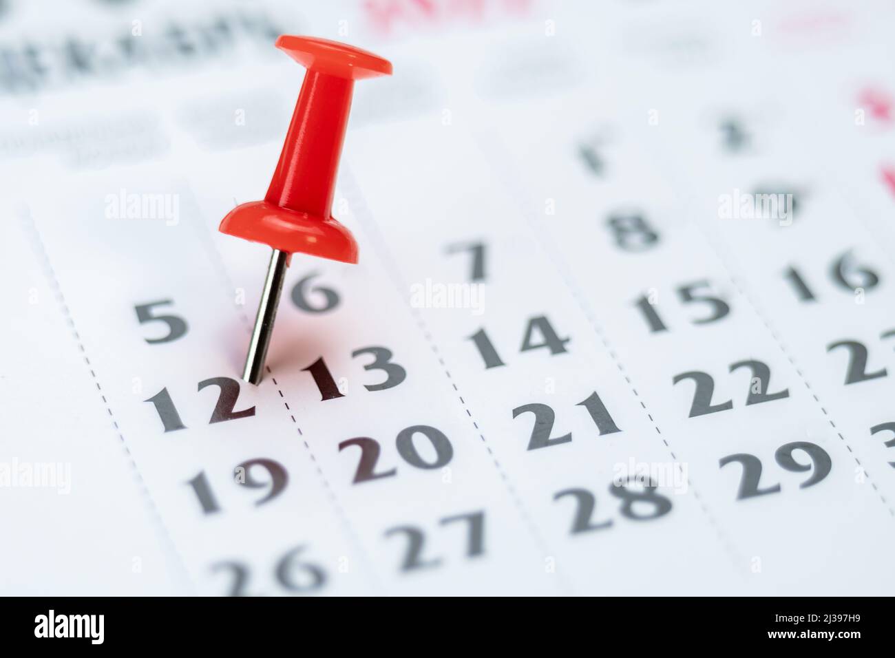 Red push pin on calendar 12th day of the month, mark the Event day with ...