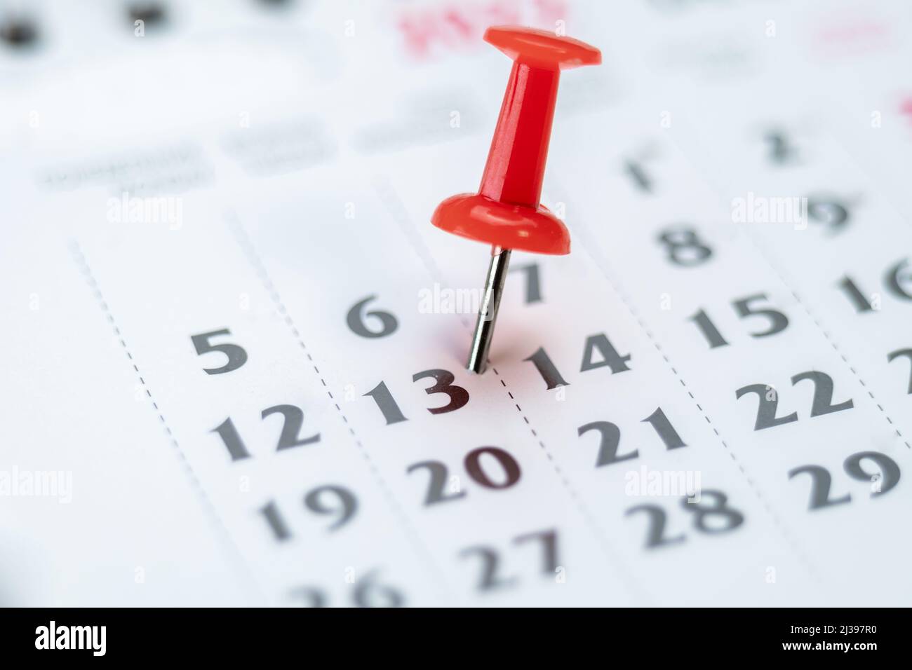 Red push pin on calendar 13th day of the month, mark the Event day with ...