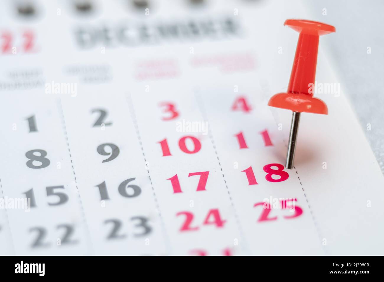 Red push pin on calendar 18th day of the month, mark the Event day with ...