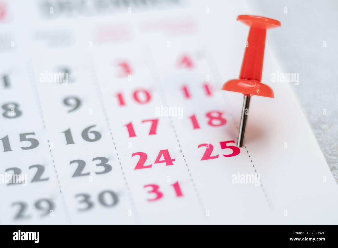 Red push pin on calendar 25th day of the month, mark the Event day with ...