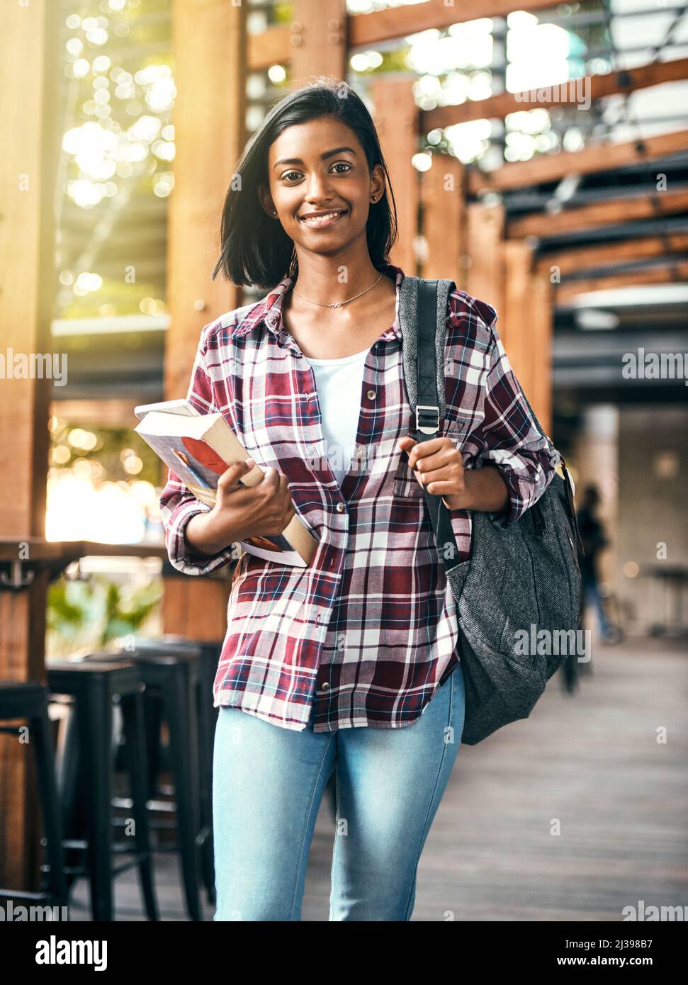 College life suits her. Cropped shot of a young female student holding ...