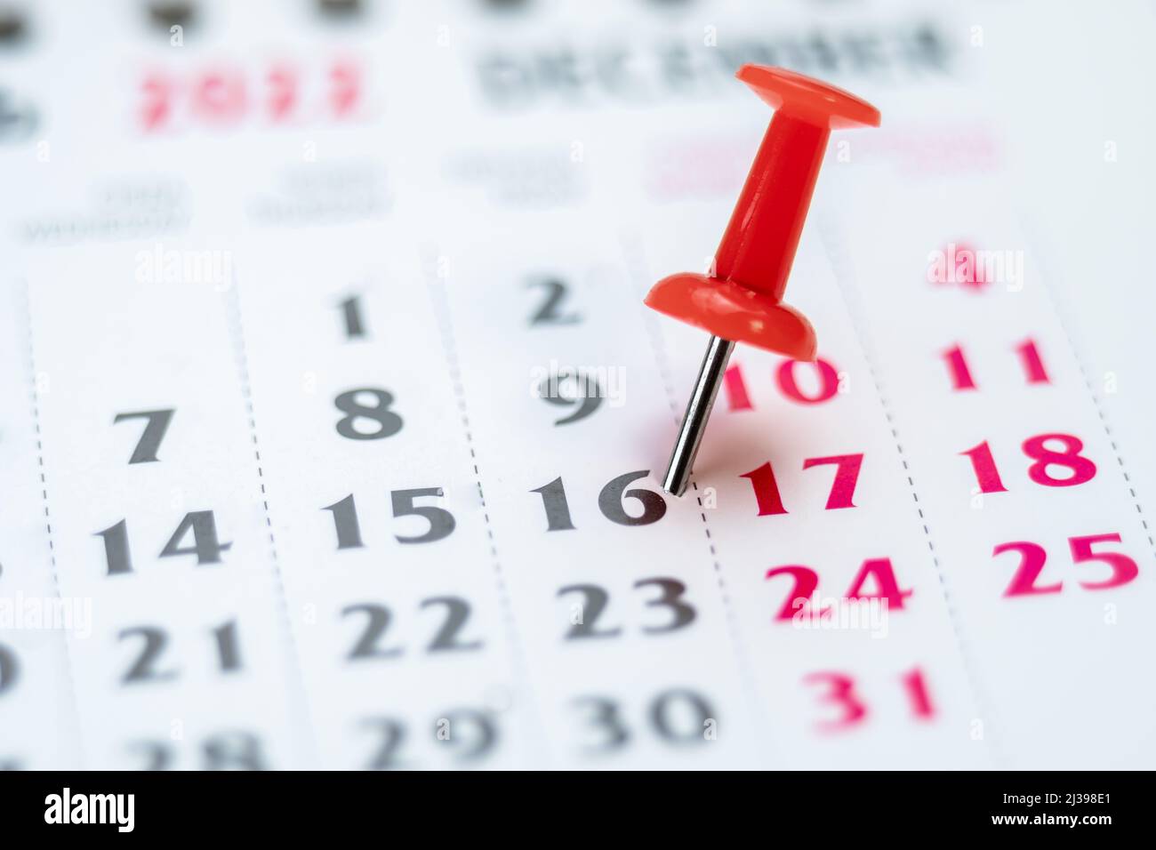 Red push pin on calendar 16th day of the month, mark the Event day with ...