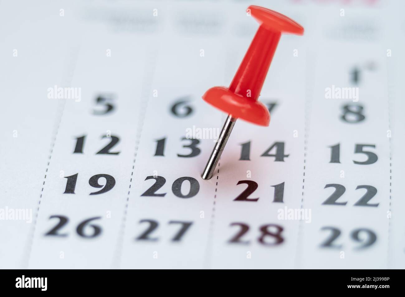 Red push pin on calendar 20th day of the month, mark the Event day with ...