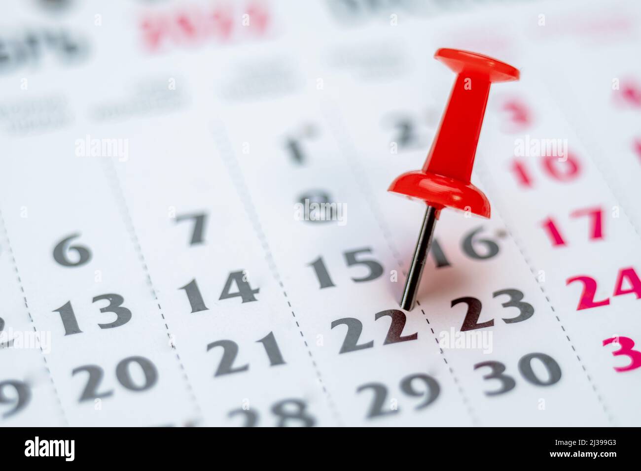 Red push pin on calendar 22th day of the month, mark the Event day with ...