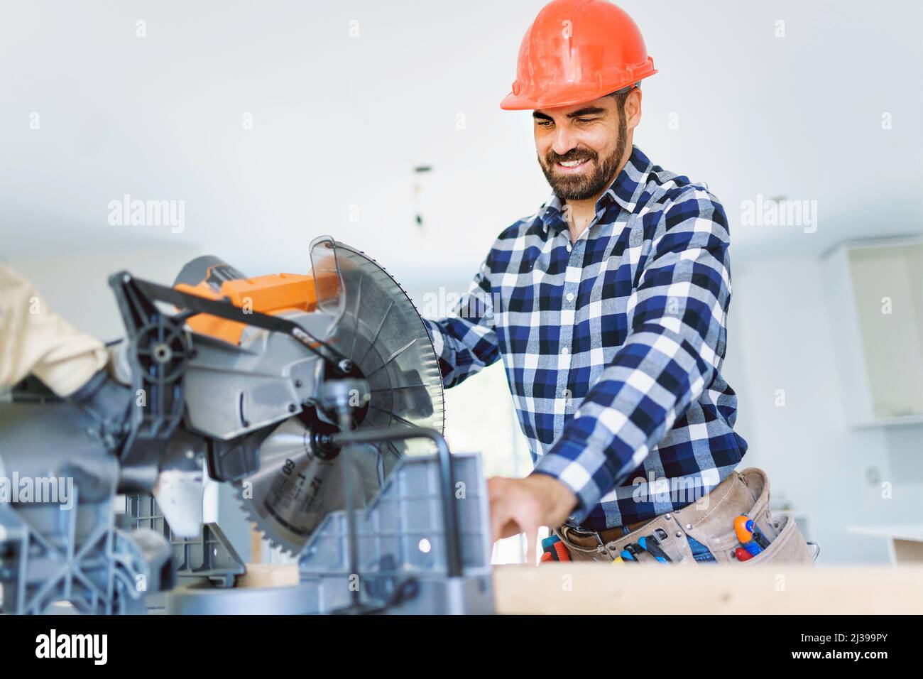 Carpenter at work on job using power tool Stock Photo - Alamy