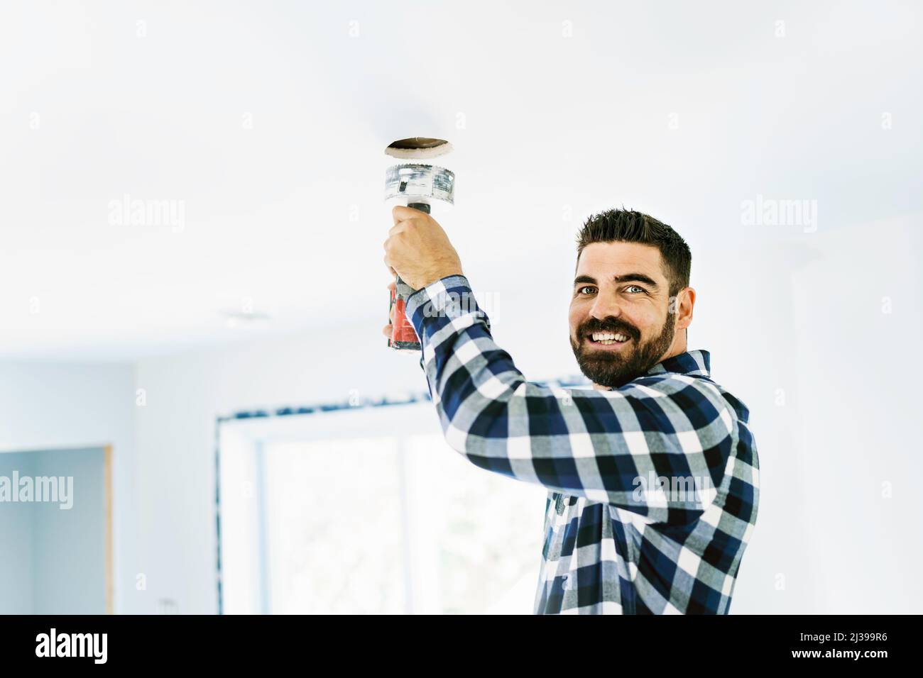 Portrait of an electrician happy worker at work install light Stock ...