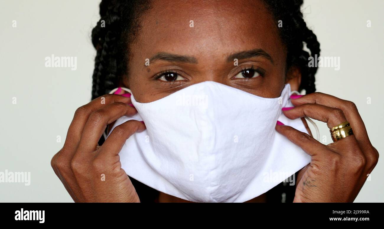 African woman putting face mask hi-res stock photography and images - Alamy