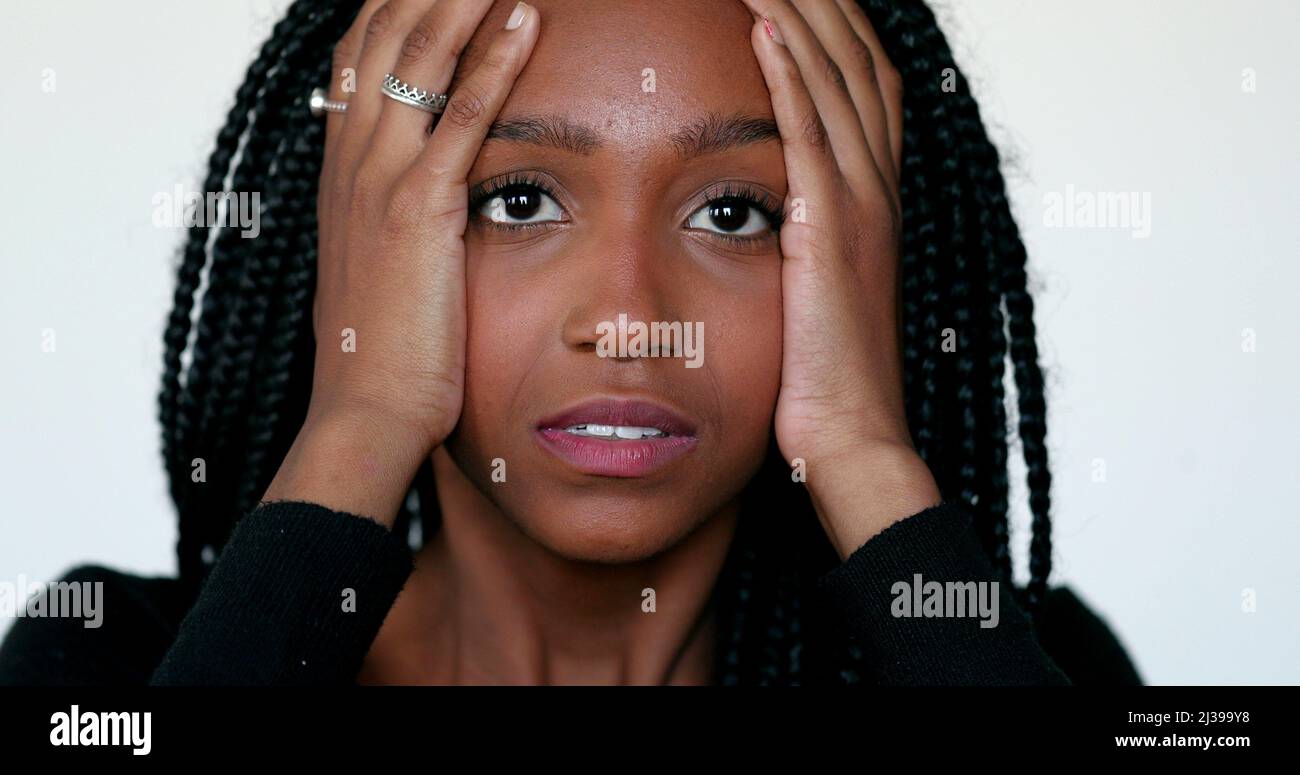 Anxious African girl emotional reaction, black teen woman hitting own ...