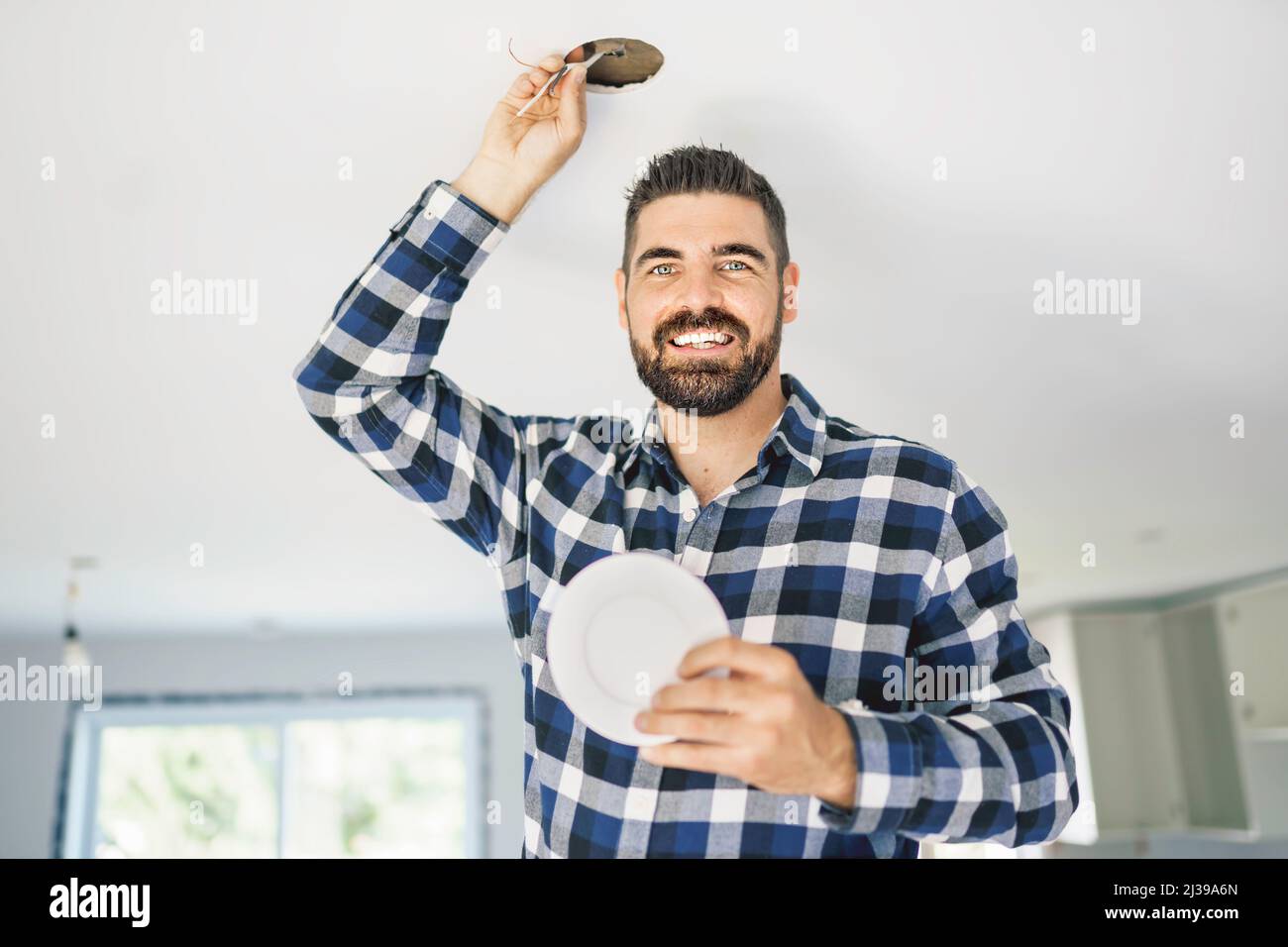 Portrait of an electrician happy worker at work Stock Photo - Alamy