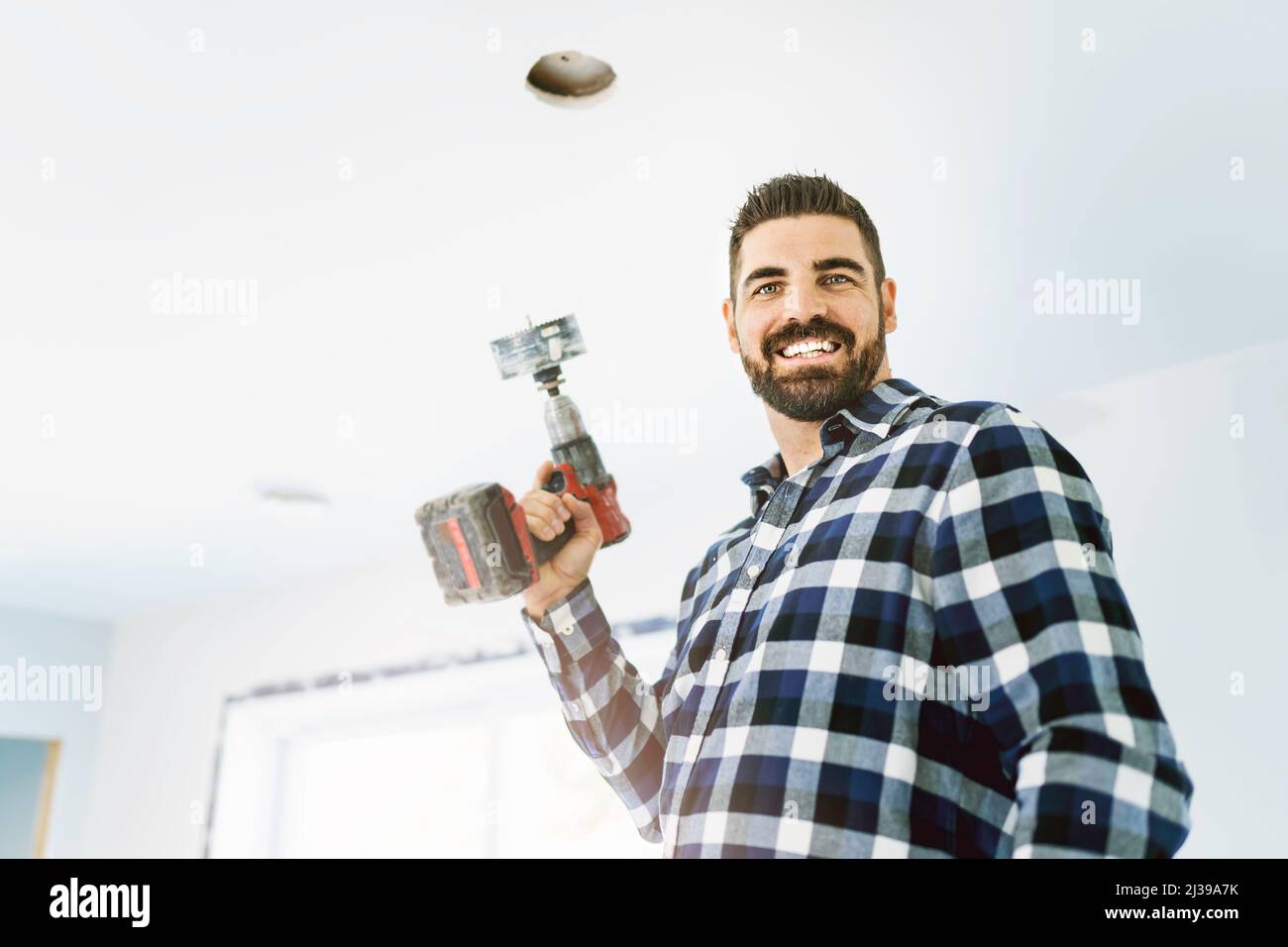 Portrait of an electrician happy worker at work install light Stock ...