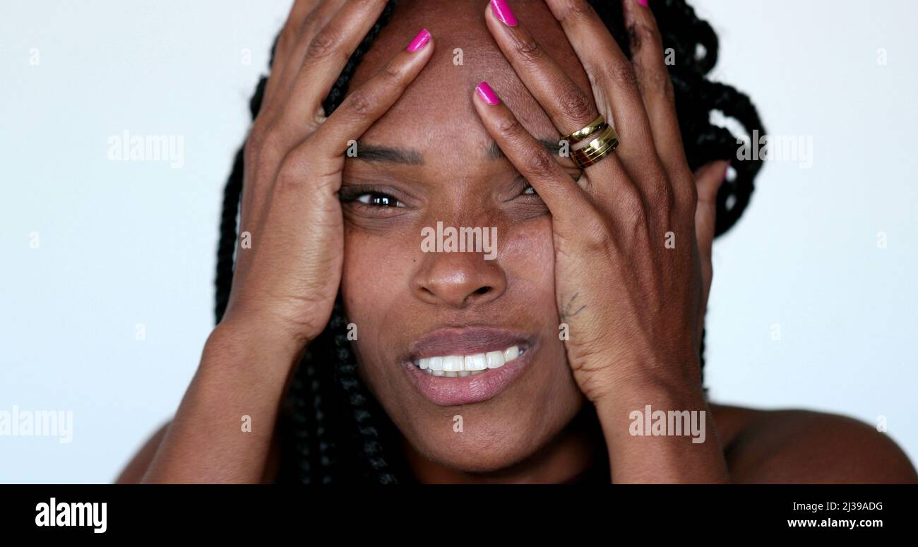 Desperate African woman screaming in HORROR to news, close-up face ...