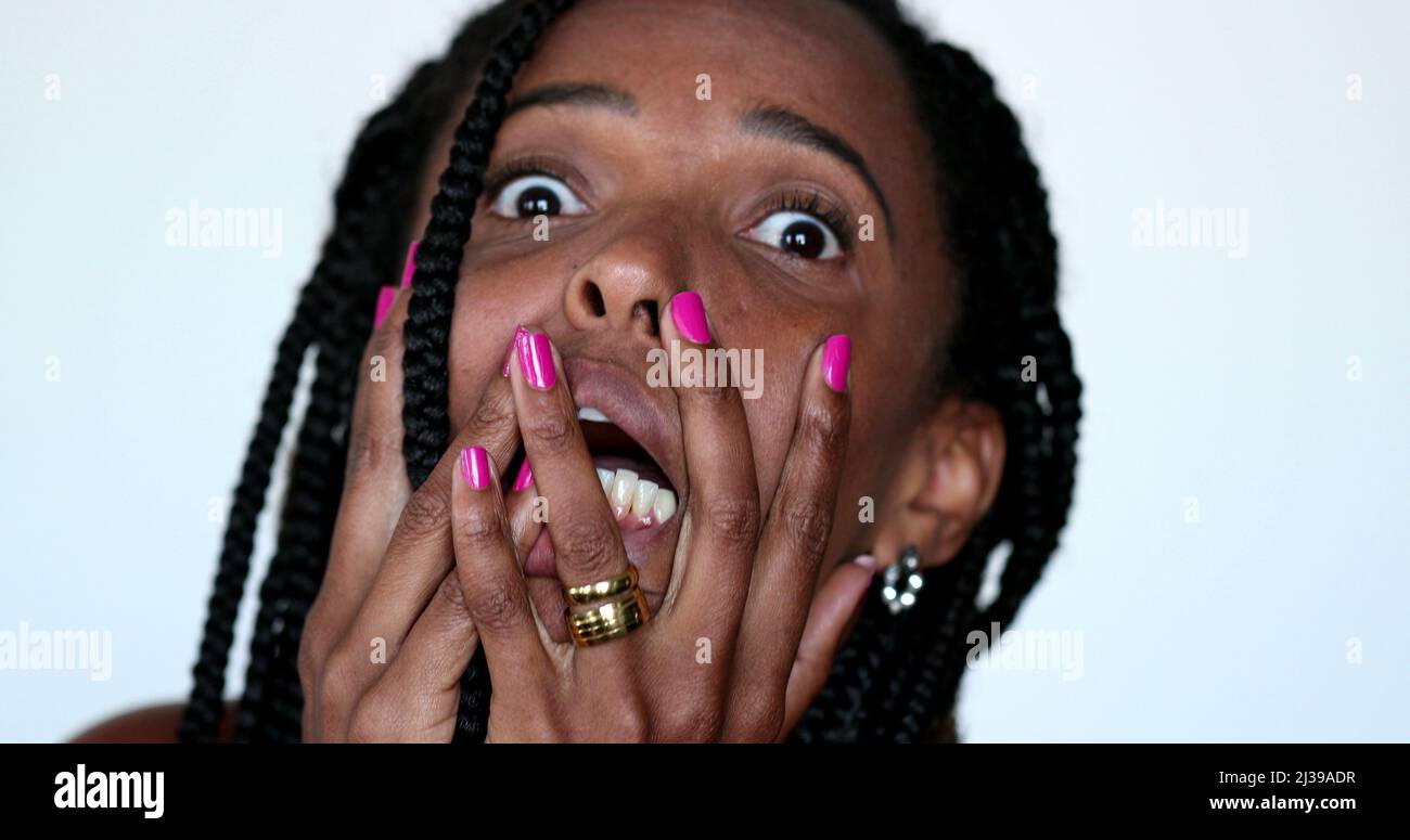 Desperate African woman screaming in HORROR to news, close-up face ...