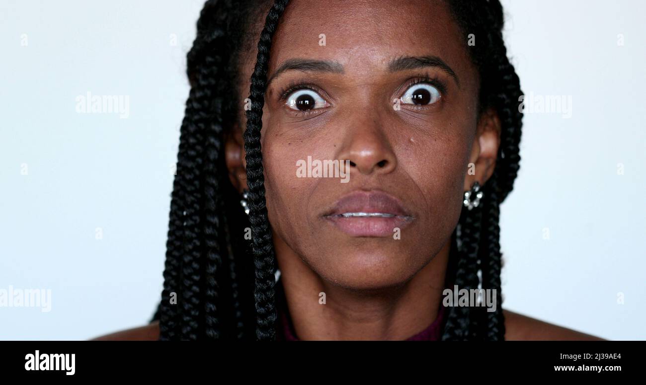 Desperate African woman screaming in HORROR to news, close-up face ...