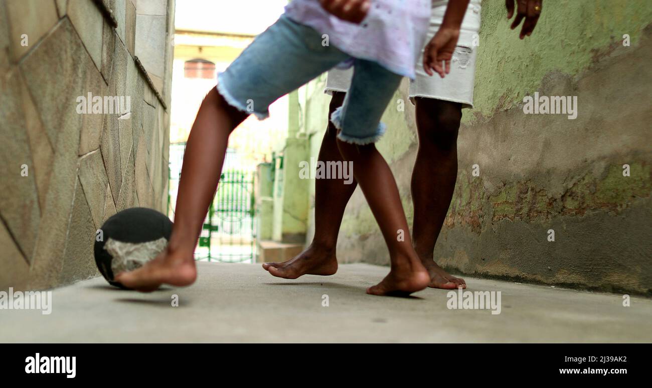 Father and son playing football together. African parent bonding with ...