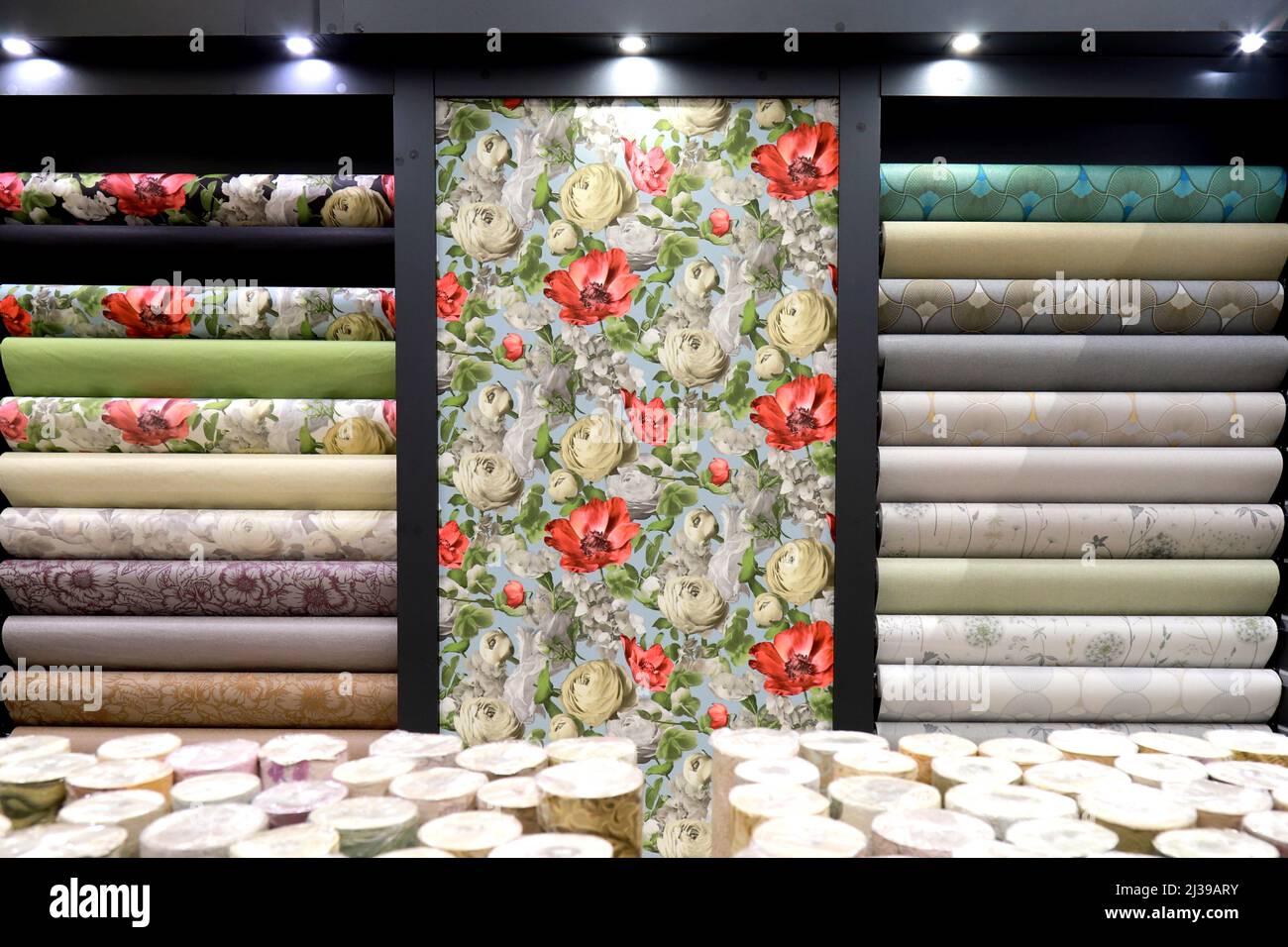 Rolls of vinyl wallpaper in building materials store. Various textures ...