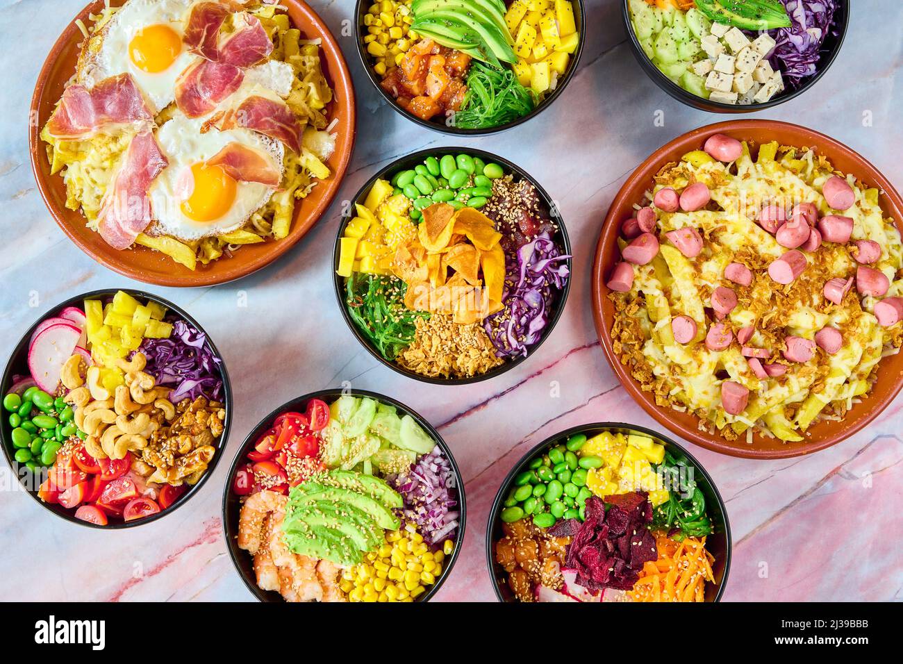 A plates stuffed with different types of food placed on a pink table ...
