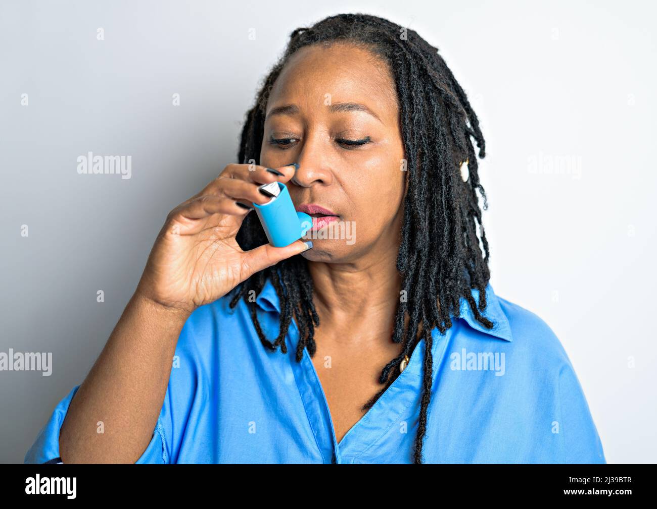 nice Portrait of an african woman holding asthma inhalor Stock Photo ...