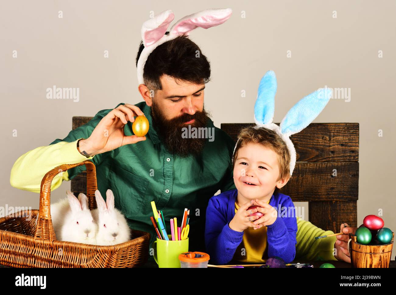 Happy easter. Family father and child son in bunny ears getting ready ...