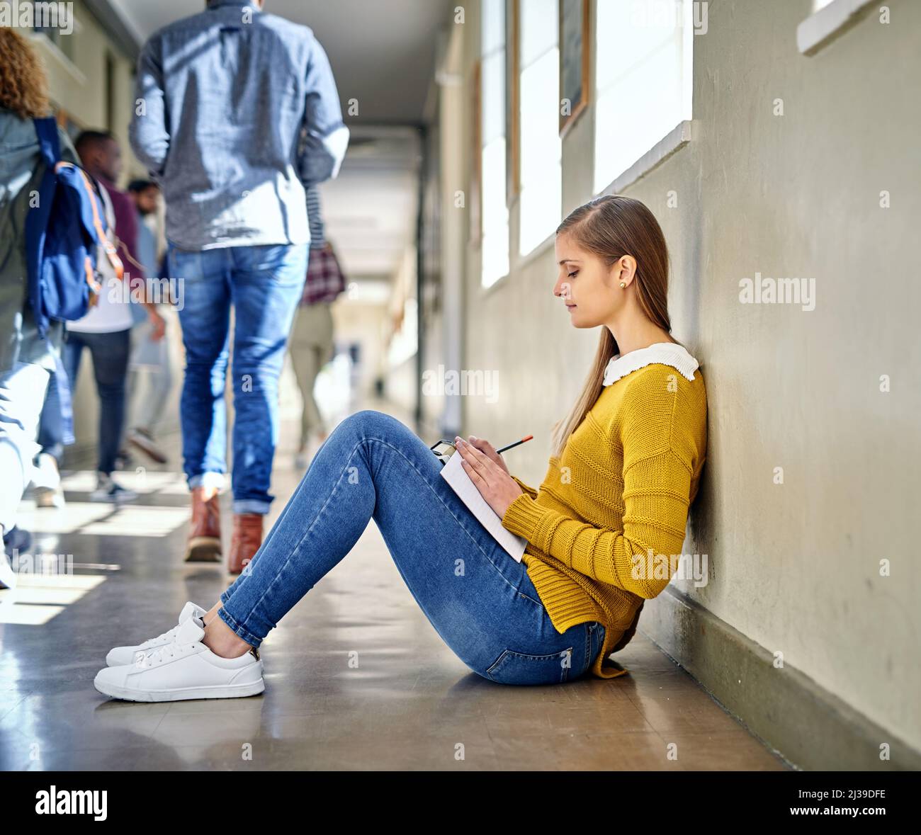 Getting her study on. Full length shot of an attractive young female ...