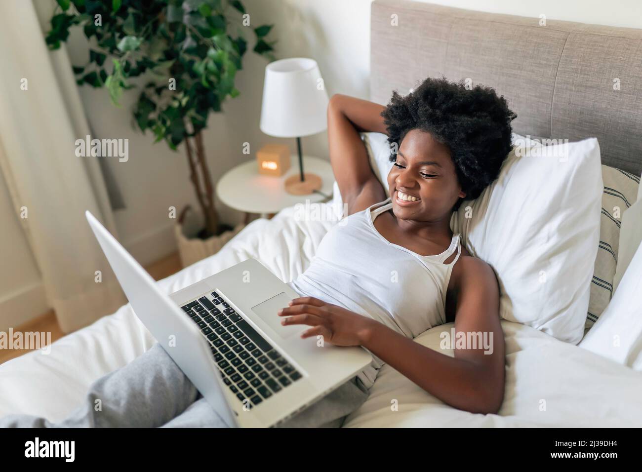 Young black woman using hi-res stock photography and images - Alamy