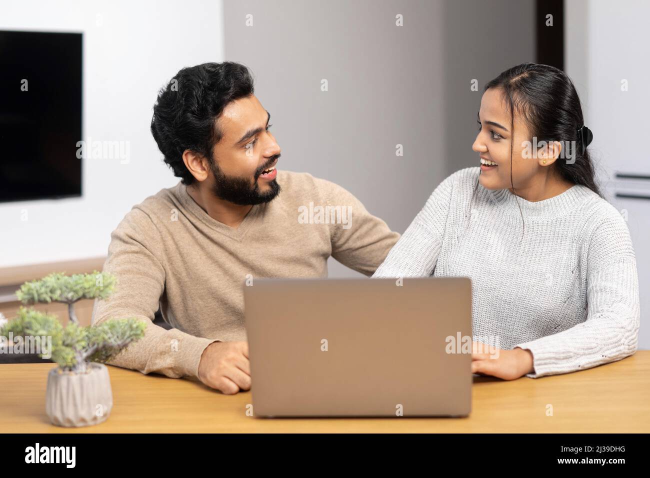 Video call with friends. Cheerful married couple using laptop for video ...
