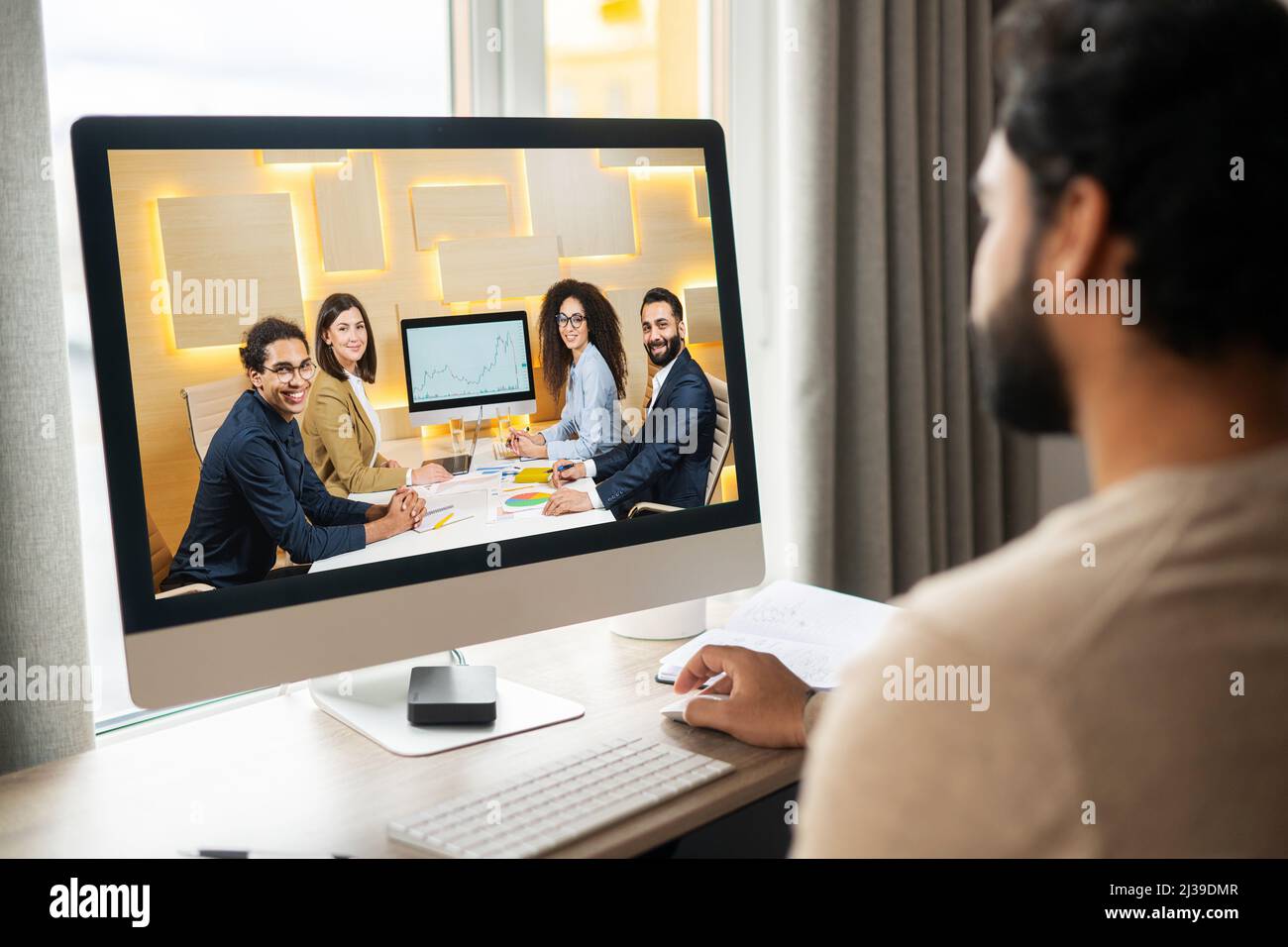 Friendly intelligent male freelancer using computer for work online ...