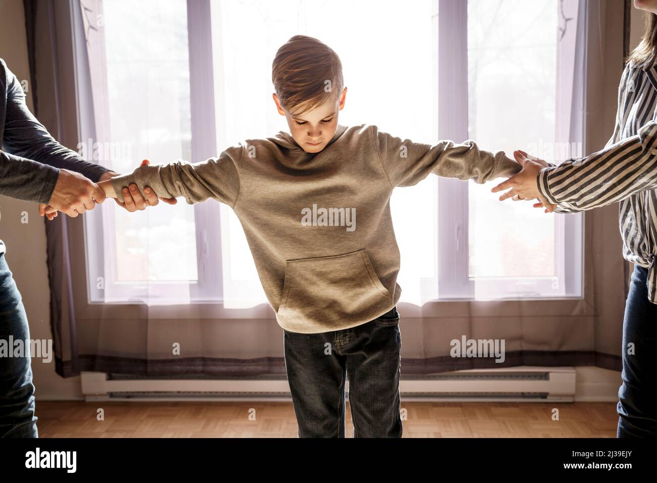 Scandal in the family the Parents pull on the hand of children Stock ...