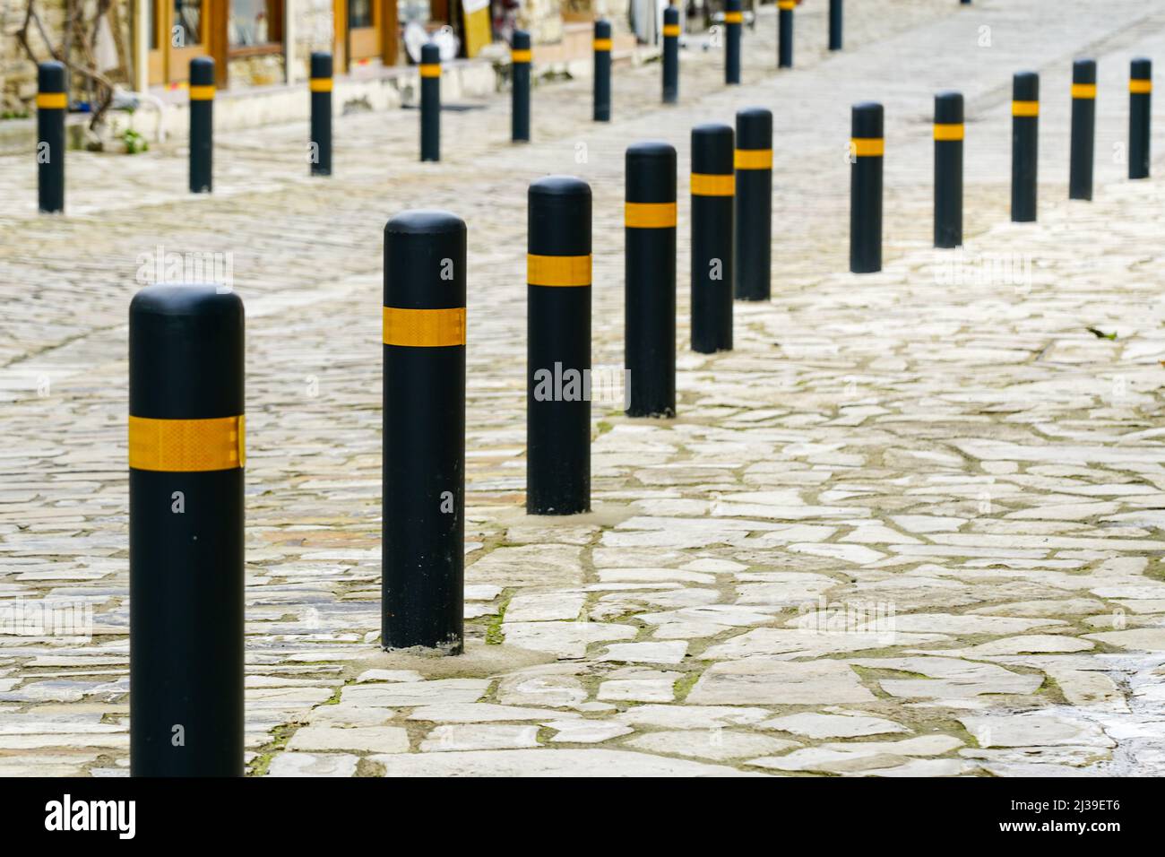 protection of a paved sidewalk from the driveway with black and yellow ...