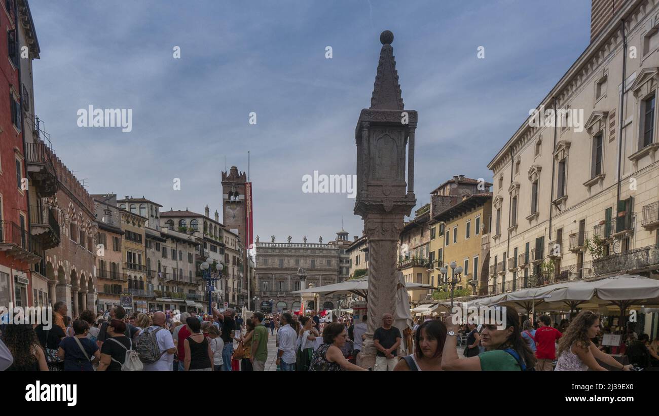 A view of a busy street full of tourists and beautiful buildings in ...