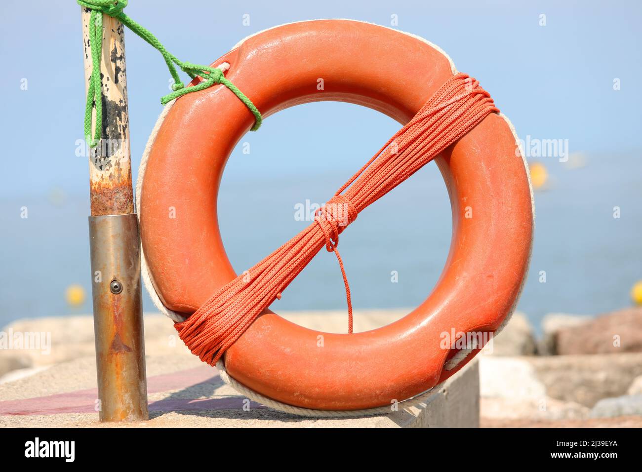 plastic orange lifebuoy on the rocks is a tool for the protection of ...