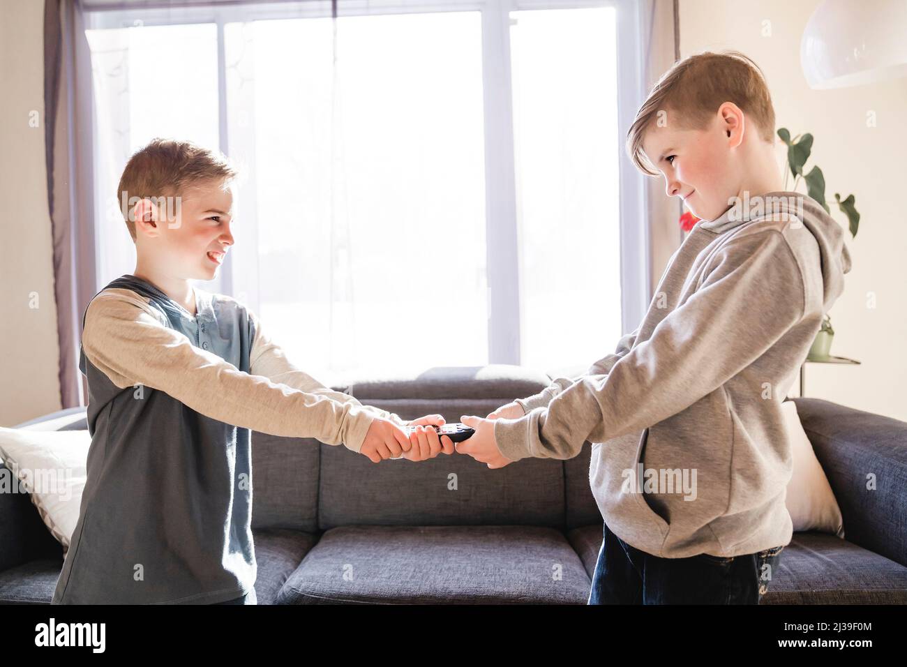 Fighting for the tv remote hi-res stock photography and images - Alamy