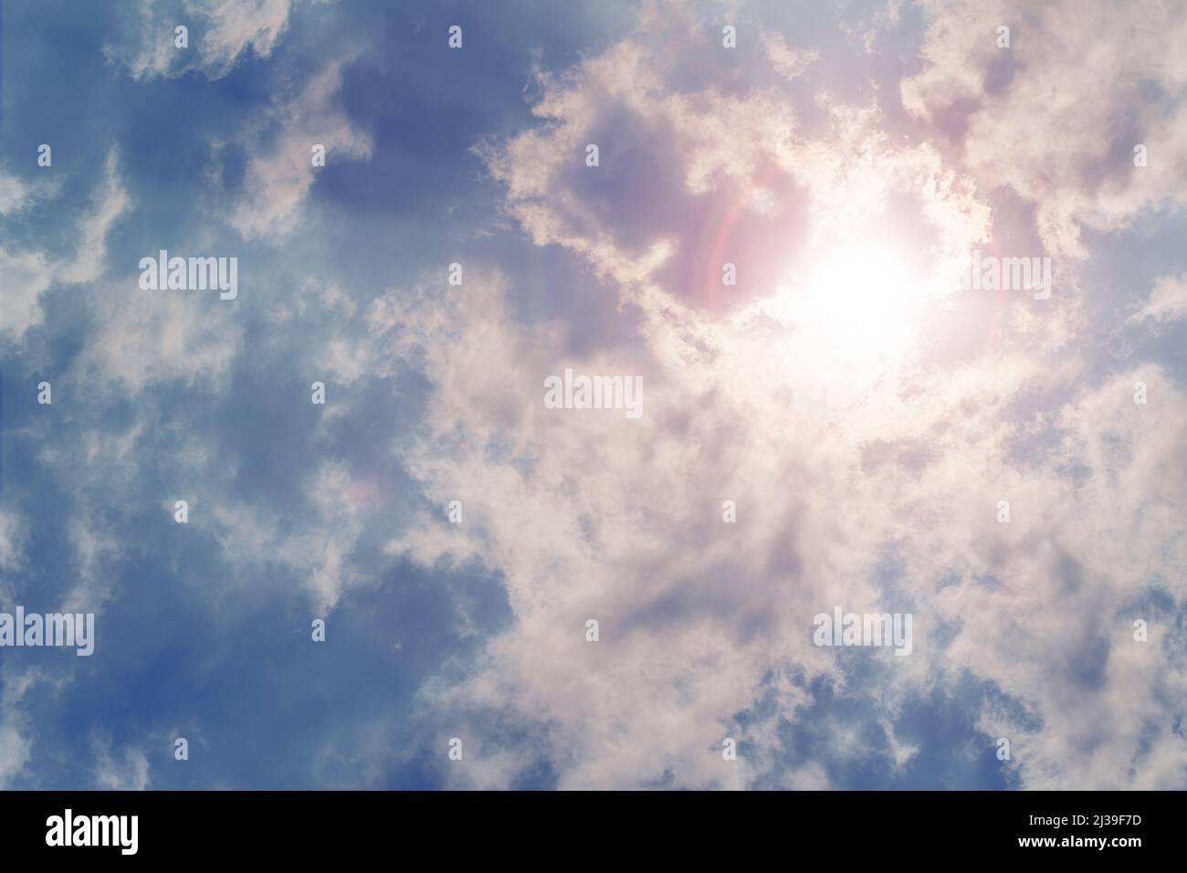 Sun shining through rain clouds. Dramatic cloudscape with halo Stock ...