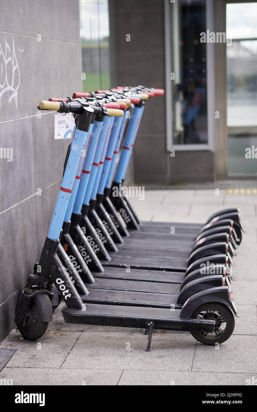 A vertical shot of a row of electric rental scooters in the city center ...