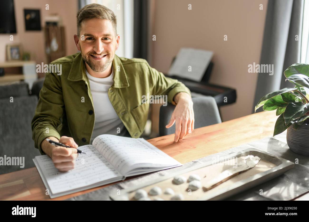 men sit on kitchen table with music sheet Stock Photo - Alamy