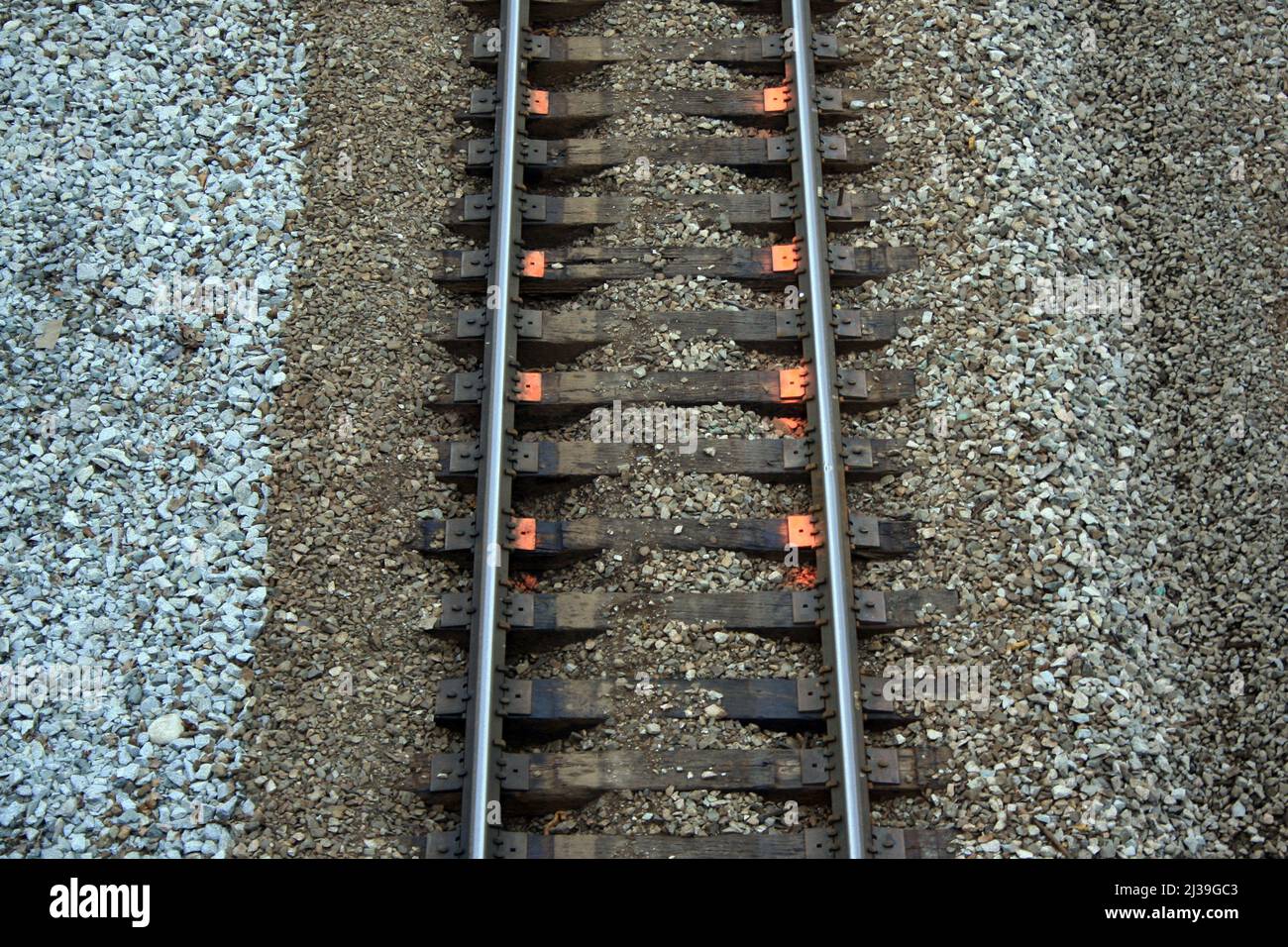 A closeup of train railways in a station Stock Photo - Alamy