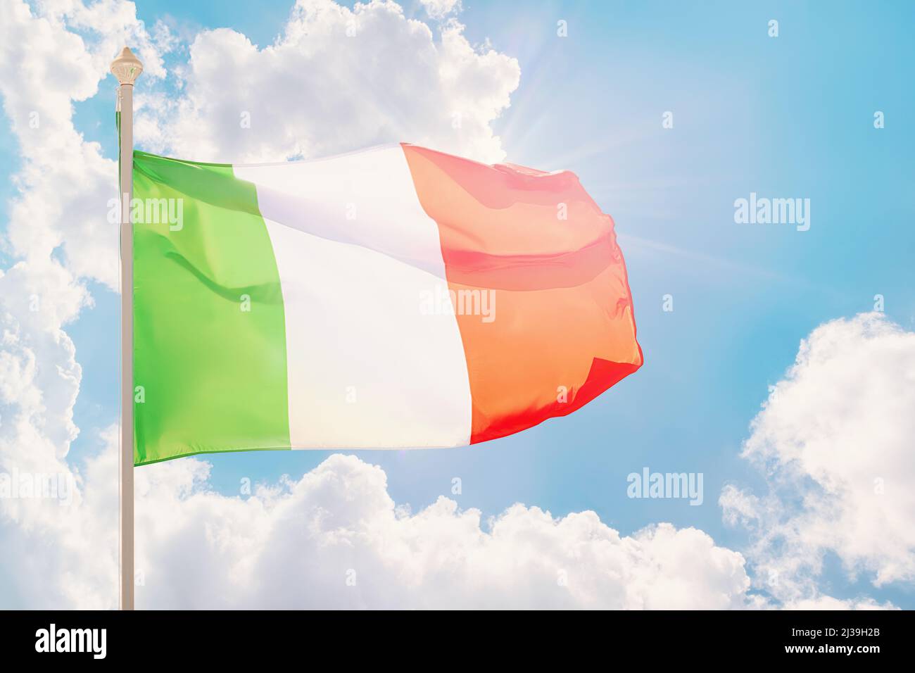 Italian flag on flagpole against the sun and cloudy sky Stock Photo - Alamy