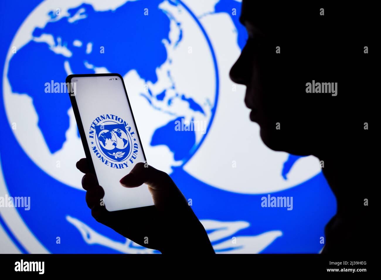 In this photo illustration, a woman's silhouette holds a smartphone ...