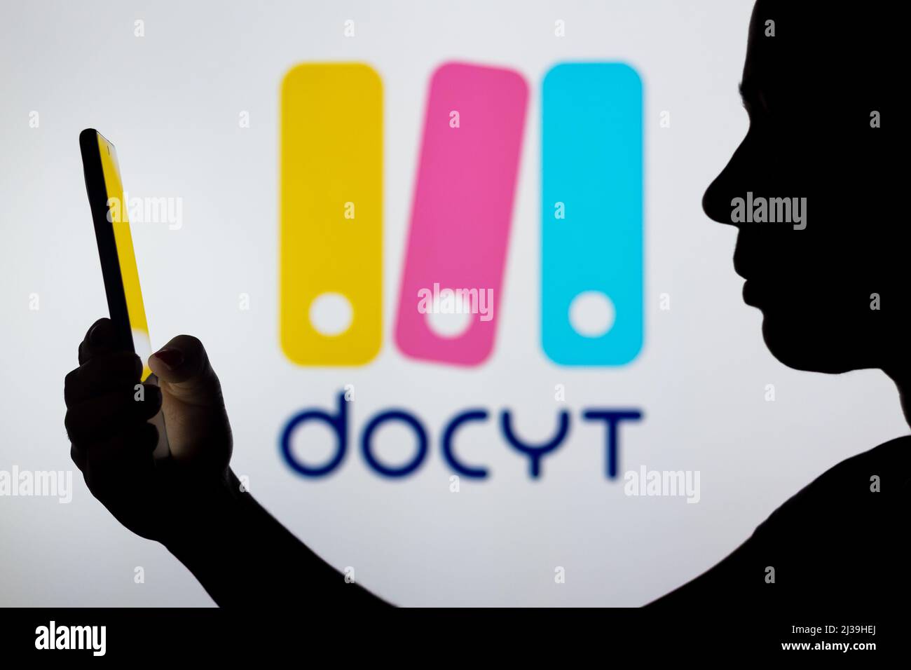 In this photo illustration, a woman's silhouette holds a smartphone ...