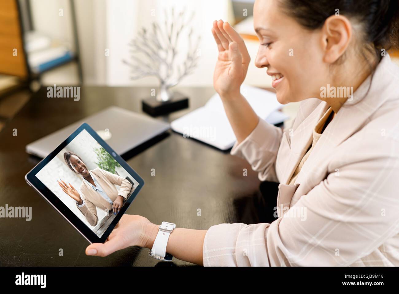 Female employee talking online with her colleague, woman participates ...